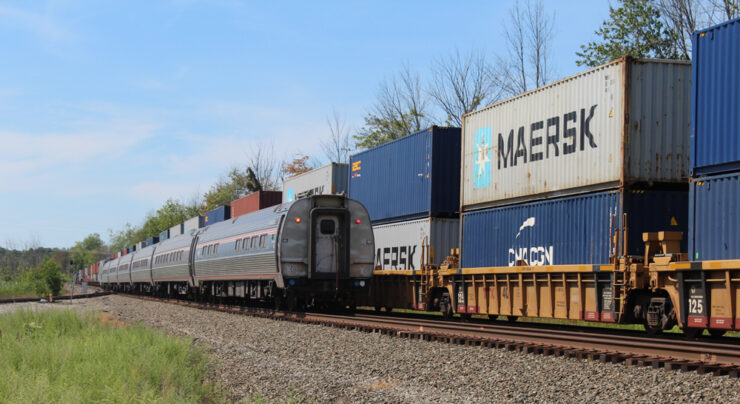 Amtrak's Maple Leaf overtakes a freight train - Trains